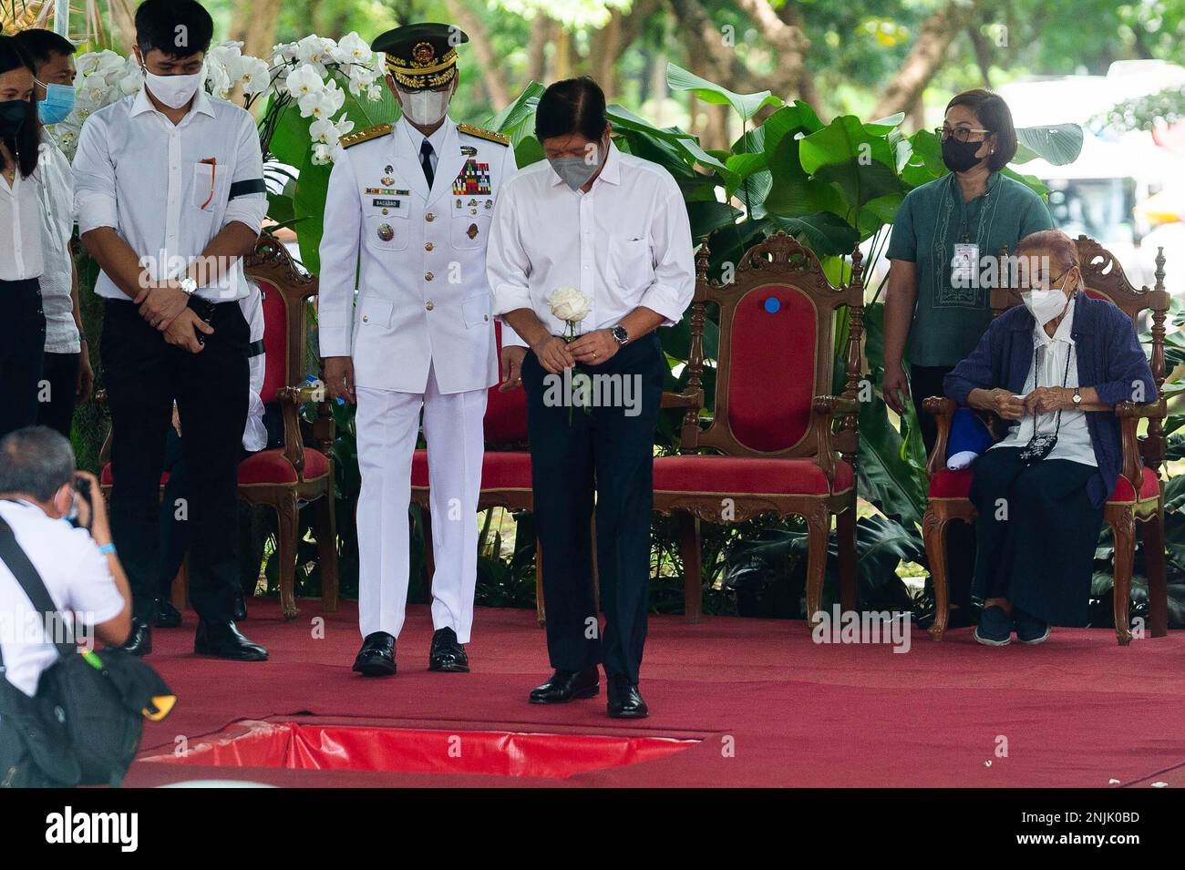 Philippine President Ferdinand Marcos Jr. prepares to throw a flower during the state funeral of ...