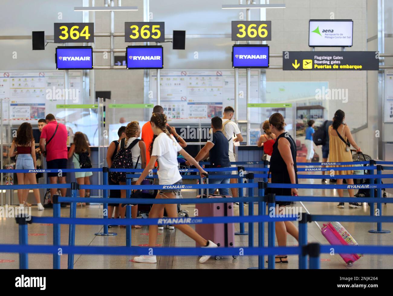 Hundreds of tourists queue at Ryanair boarding stations at the Costa ...