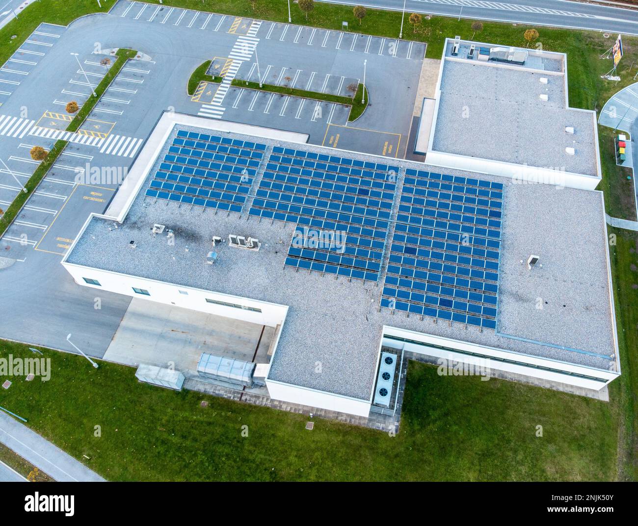 Commercial building (store) with solar panels on the roof. Drone shot ...