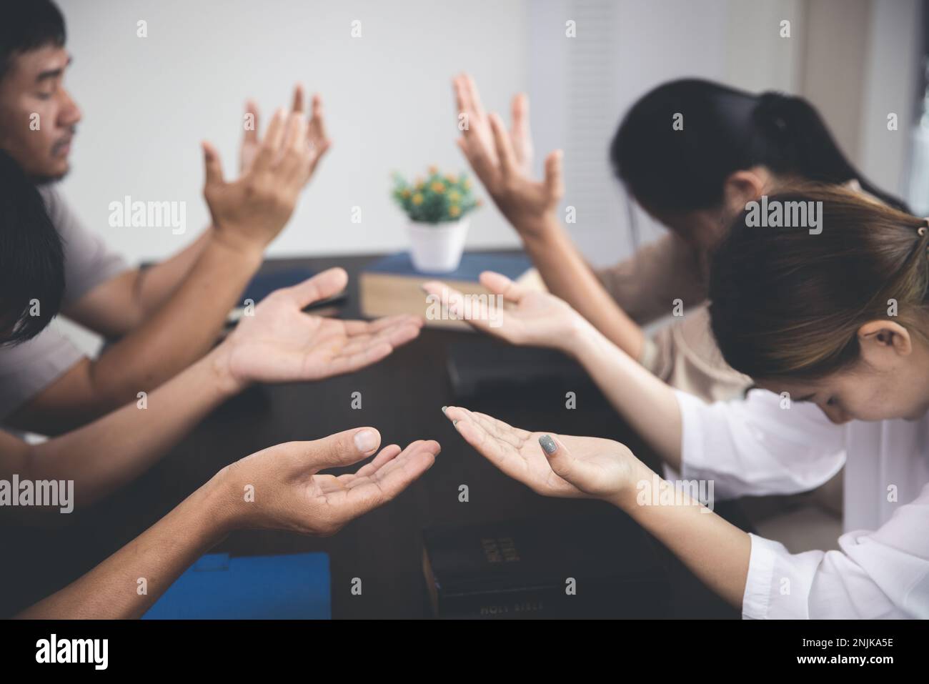 Group of people praying home christian hi-res stock photography and ...