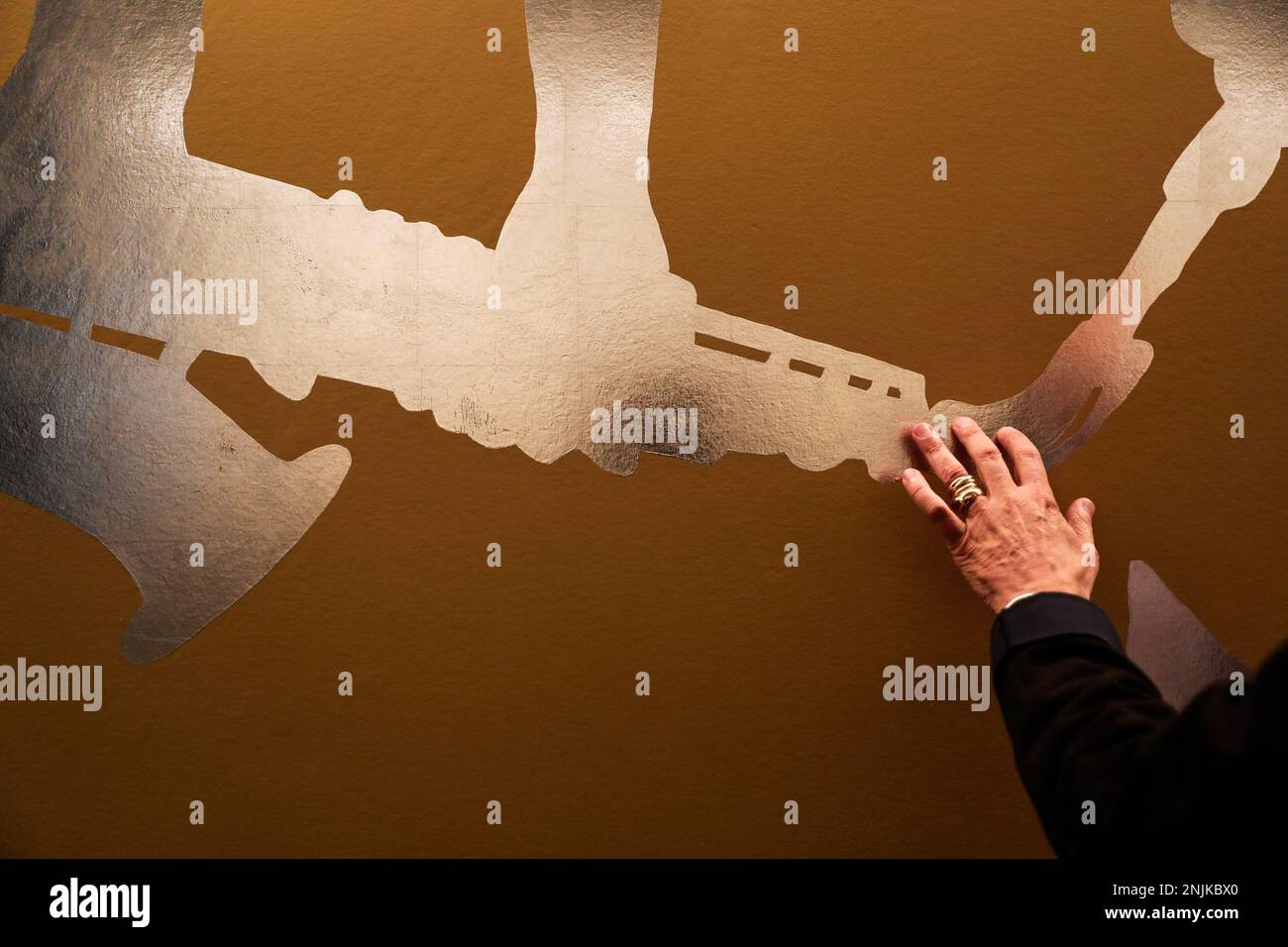 Artist Mark Evans puts his hands across the mural he made for the ...