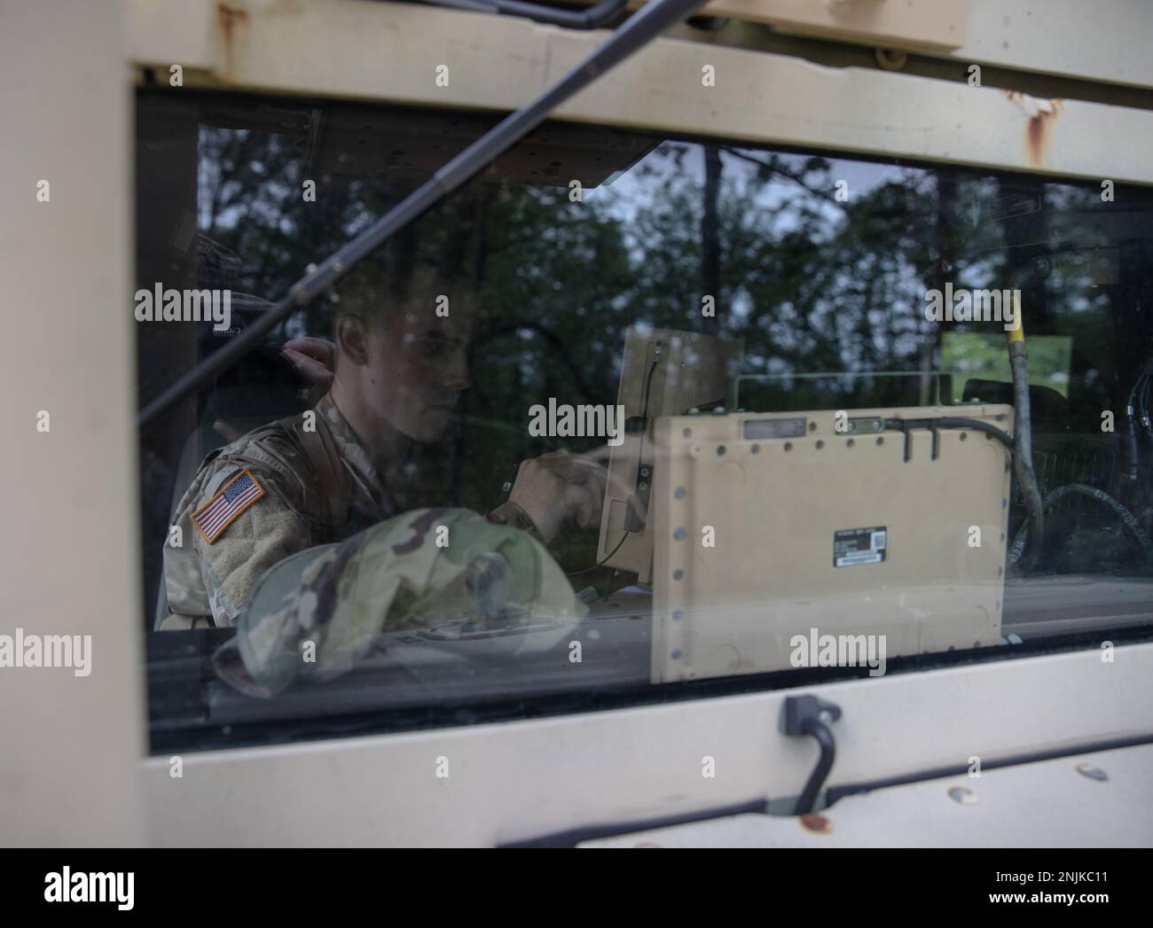 Pfc. Lawson Graham, 115 Signal Battalion, checks messages while ...