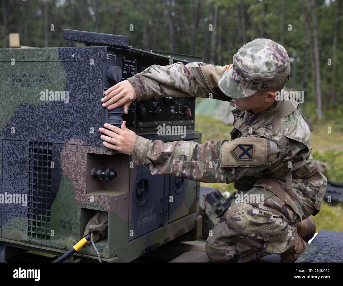 Pfc. Lawson Graham, 115 Signal Battalion, operates a generator while ...