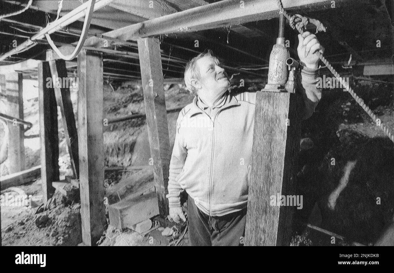 Resident Kenny Reid shores up pilings under his from his house near ...