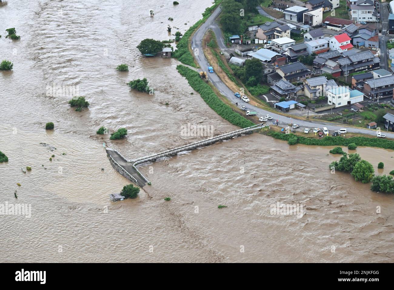 An aerial photo shows Takatoki River flooding due to torrential rain in ...