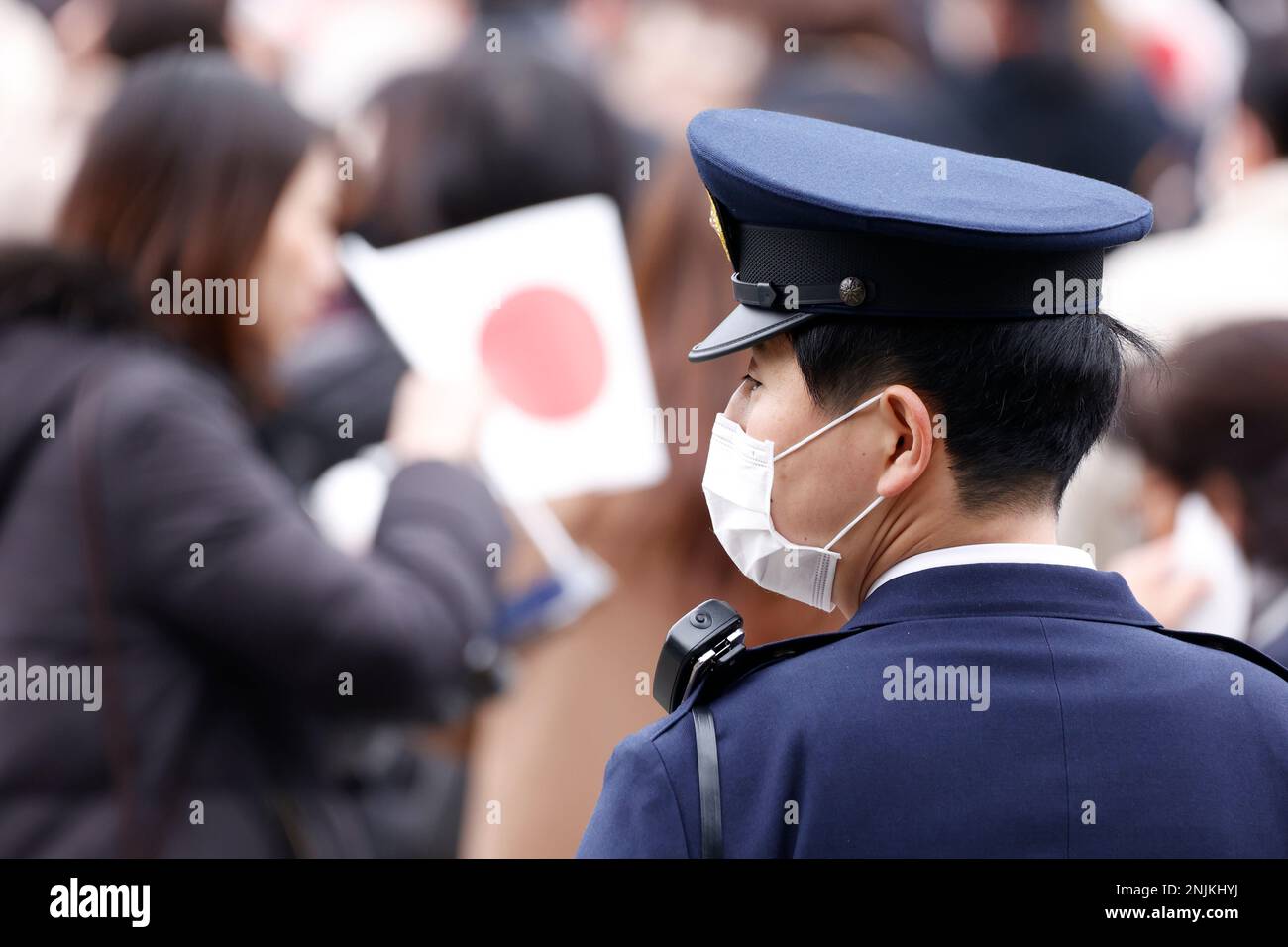 Tokyo, Japan. 30th Mar, 2018. Security guard monitors people during the ...