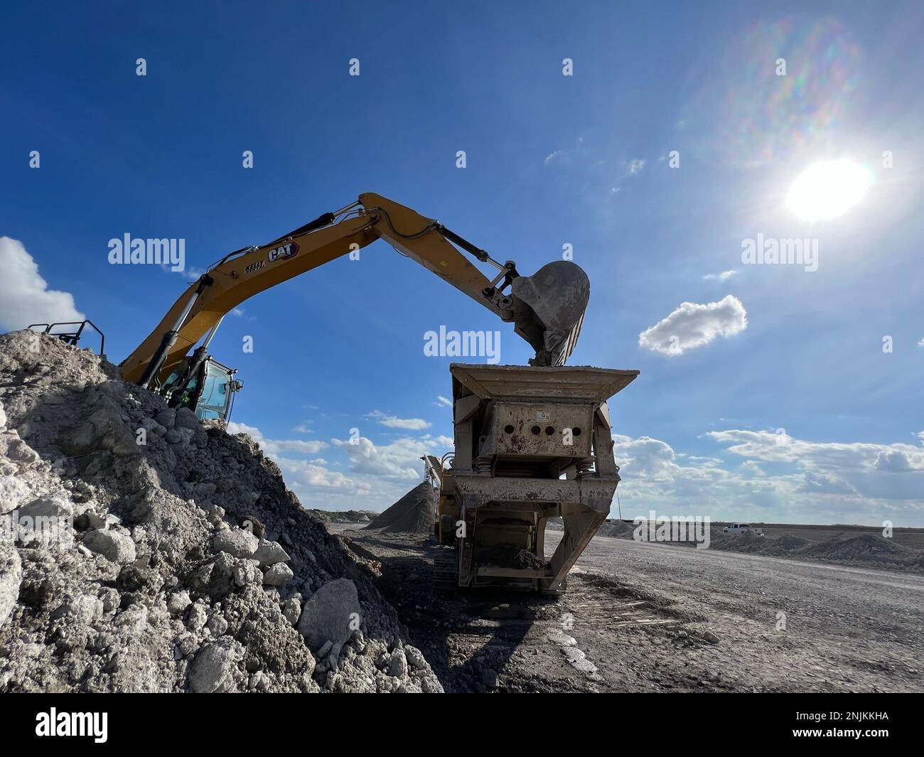 Dirt and rock are loaded into a grinder at the construction area of ...