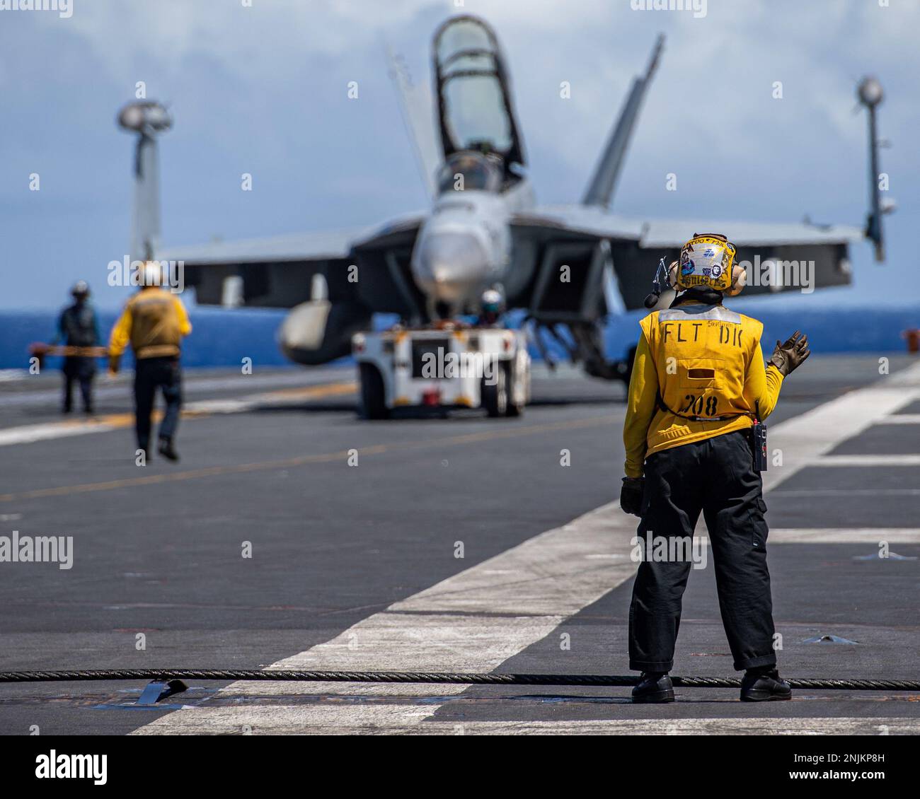 230222-N-DU622-1586 PHILIPPINE SEA (Feb. 22, 2023) A U.S. Navy Sailor directs an E/A-18G Growler ...