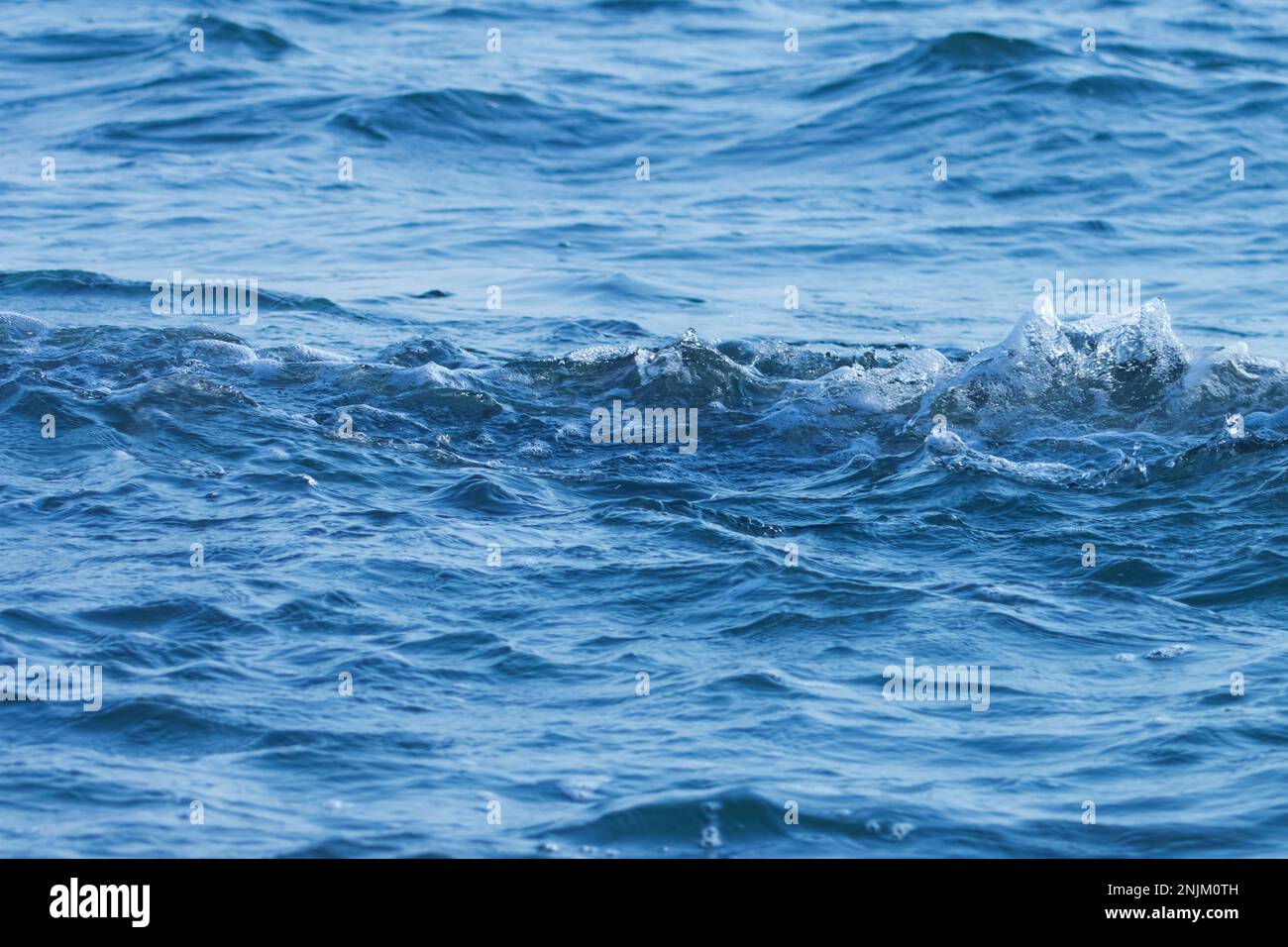 Blue ocean wave splashing on the beach. Sea wave Stock Photo - Alamy