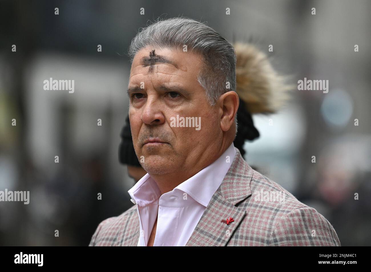 New York, USA. 22nd Feb, 2023. A man with an ash cross on his forehead ...