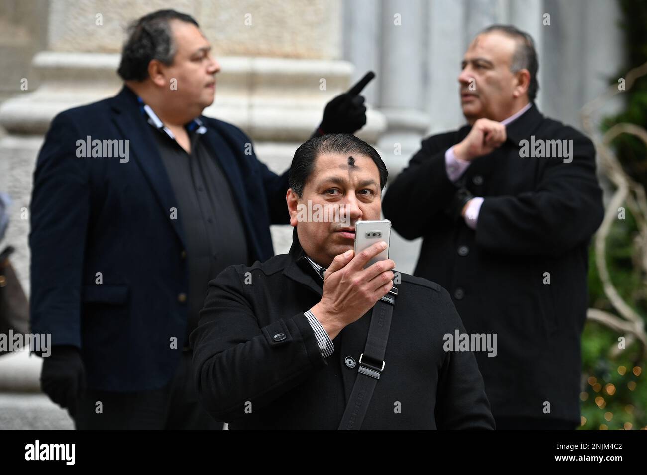 New York, USA. 22nd Feb, 2023. Three men with ash crosses on their ...