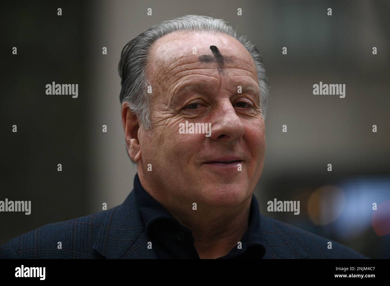 New York, USA. 22nd Feb, 2023. A man with an ash cross on his forehead ...