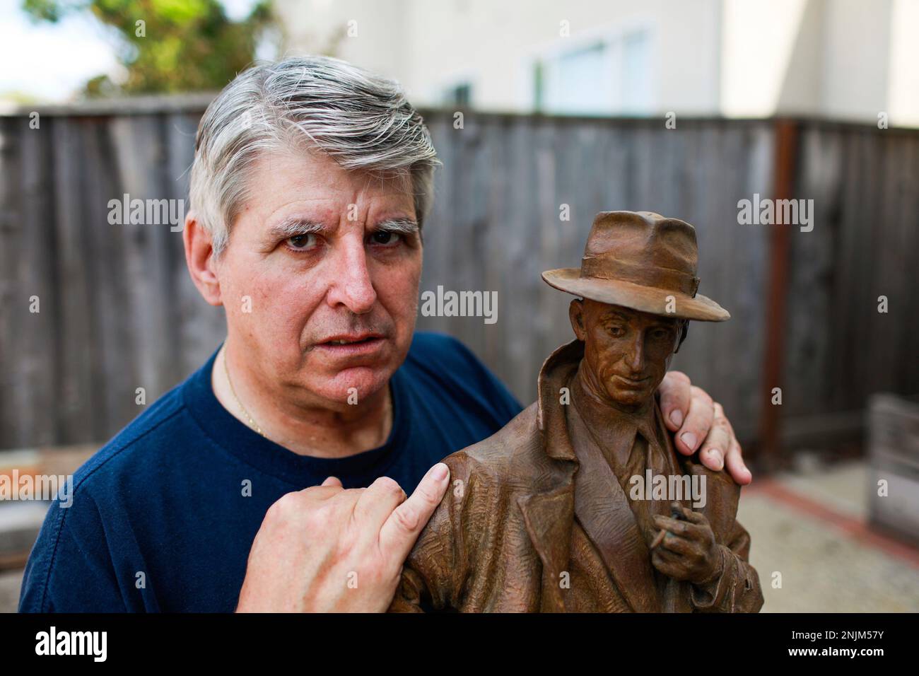 Richard Meade poses for a portrait at his home with his bronze statue ...