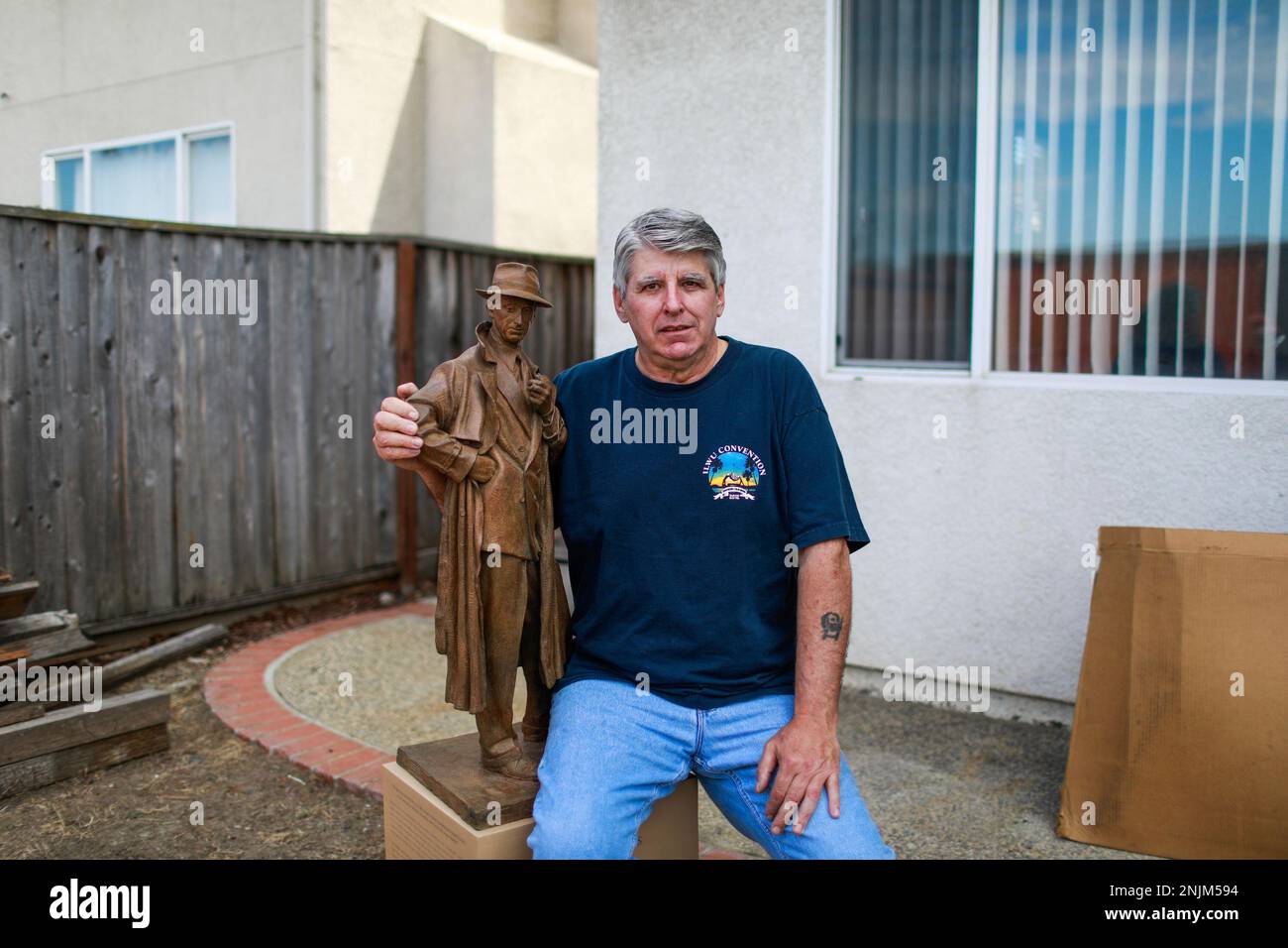 Richard Meade poses for a portrait at his home with his bronze statue ...