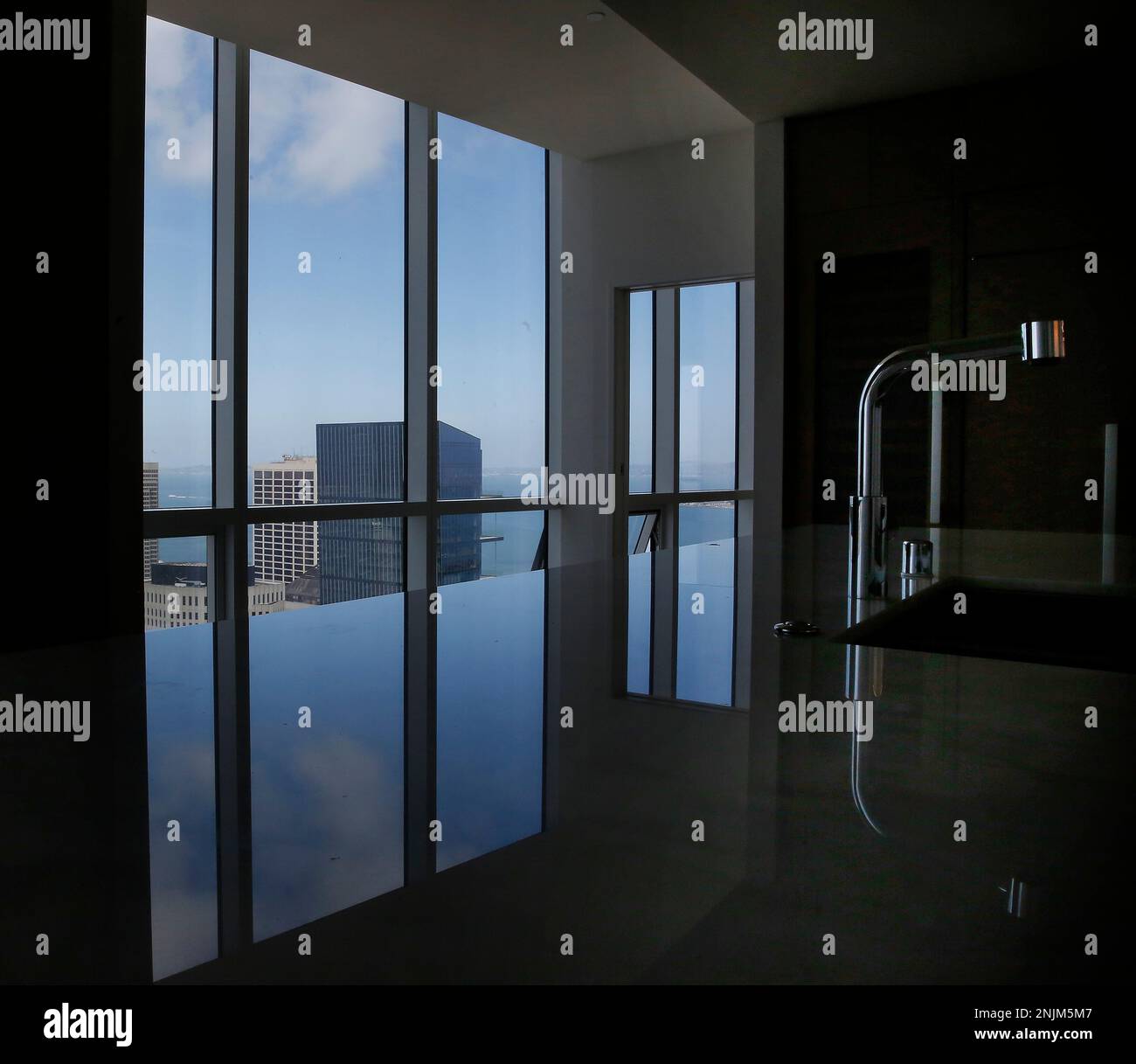 Views from windows in the open kitchen and reflected in the counter top ...