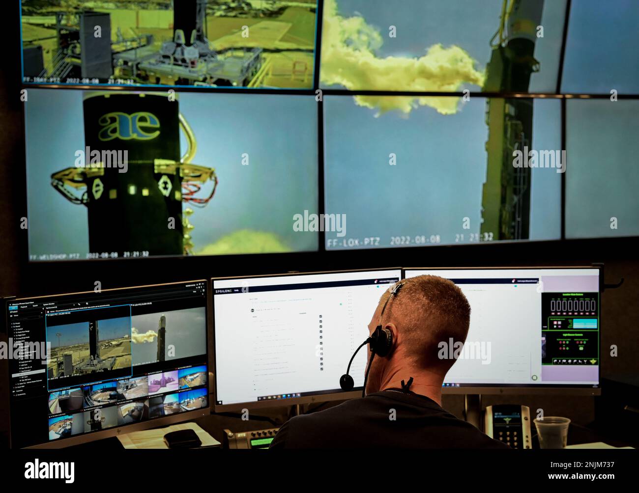 A Firefly Aerospace employee monitors computer data in preparation for ...