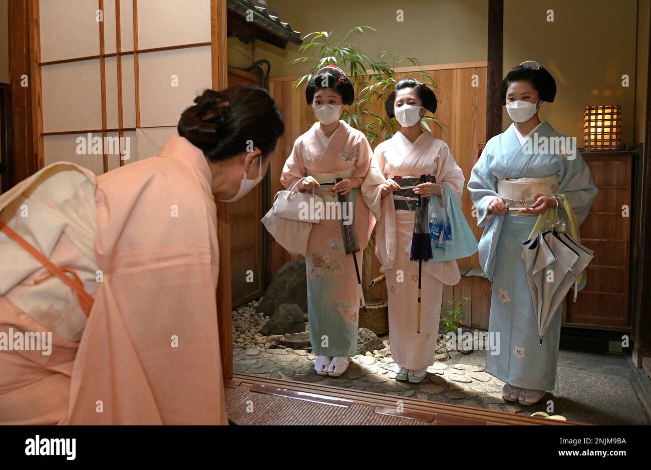 Maiko, girl who is studying to be a geisha, visit a teahouse to greet ...