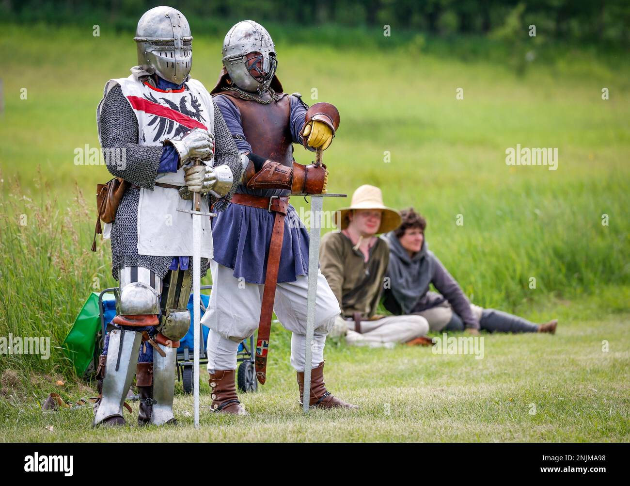 Knights of the Dragon's Own Medieval Combat Group re-enactors look on ...