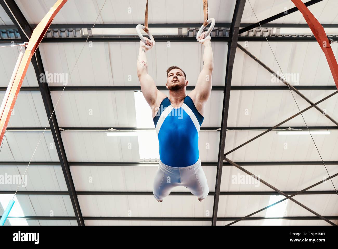 Man, acrobat and gymnastics swinging on rings in fitness for practice ...