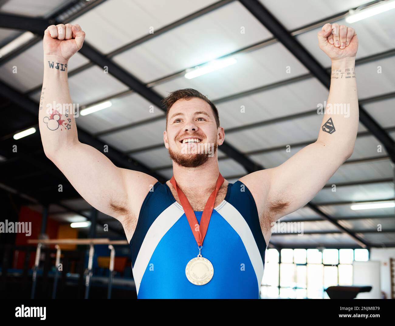 Man, medal celebration and winner with smile, indoor sports or hands in ...