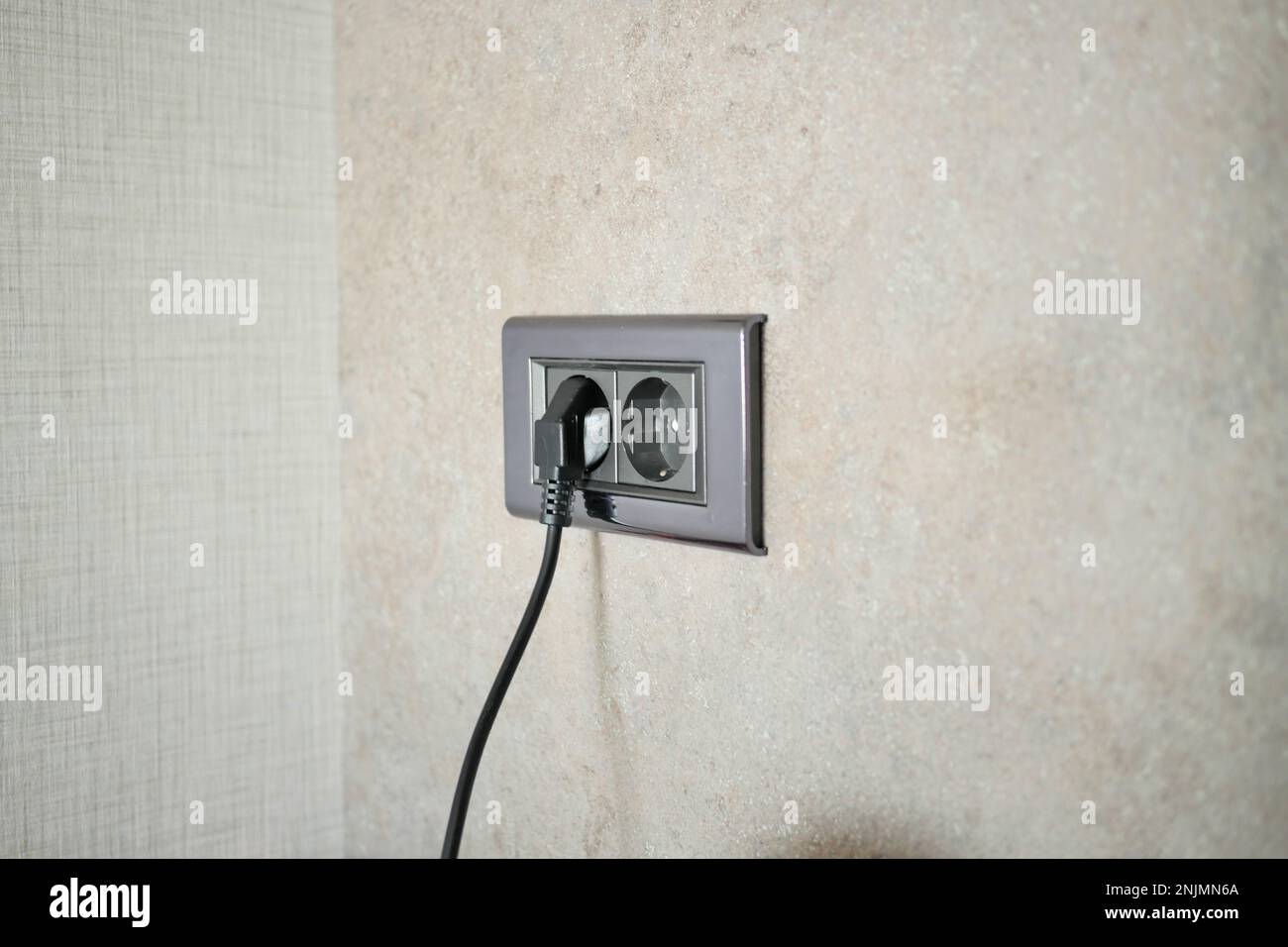 white color power cord cable plugged into wall Stock Photo - Alamy
