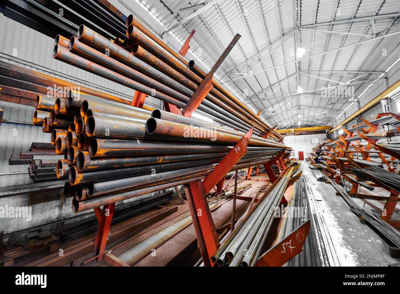 Cold rolled pipes stacked on shelving unit in plant storage Stock Photo ...