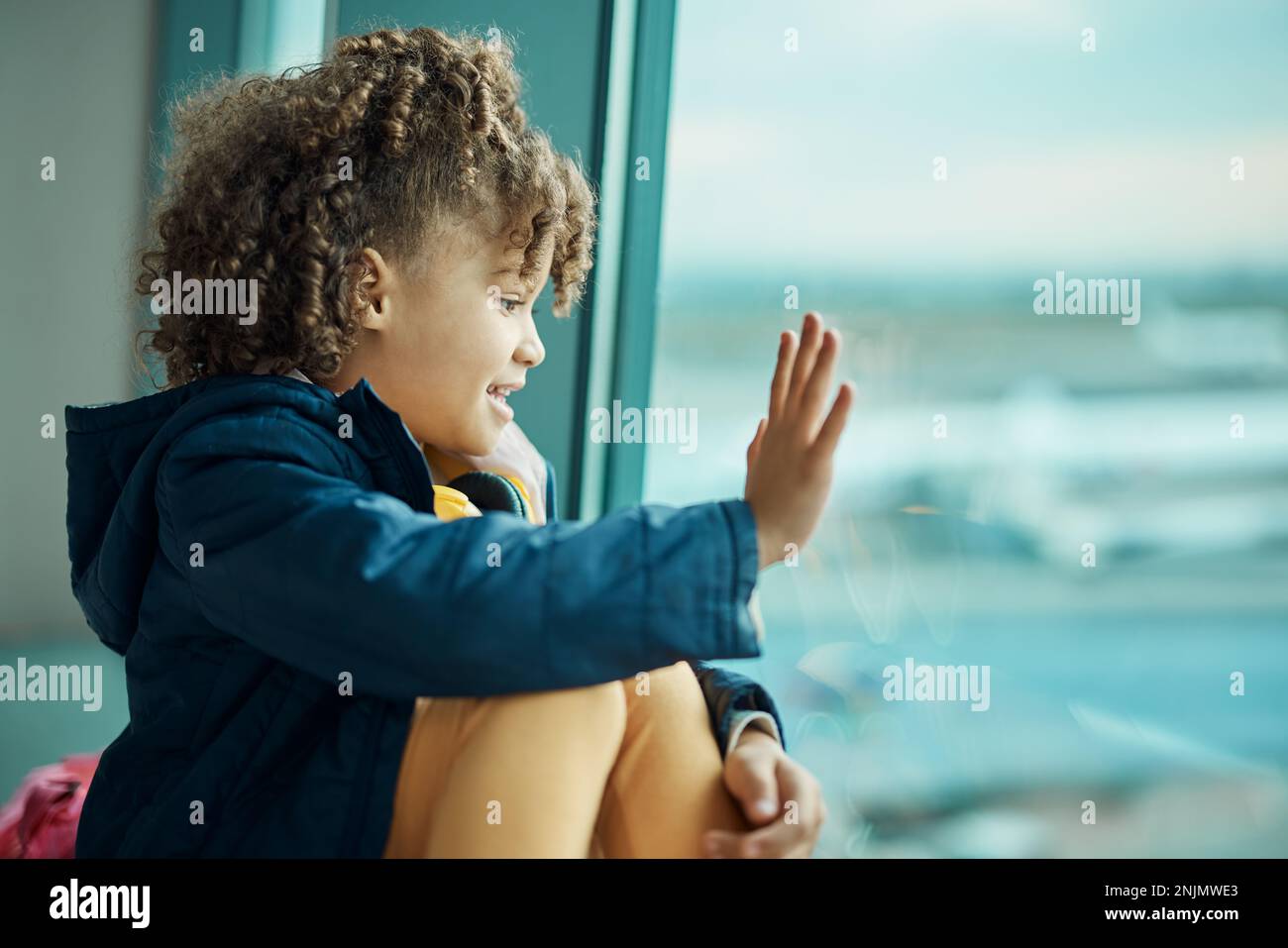 Girl child, wave and airport window for greeting, goodbye and smile for ...