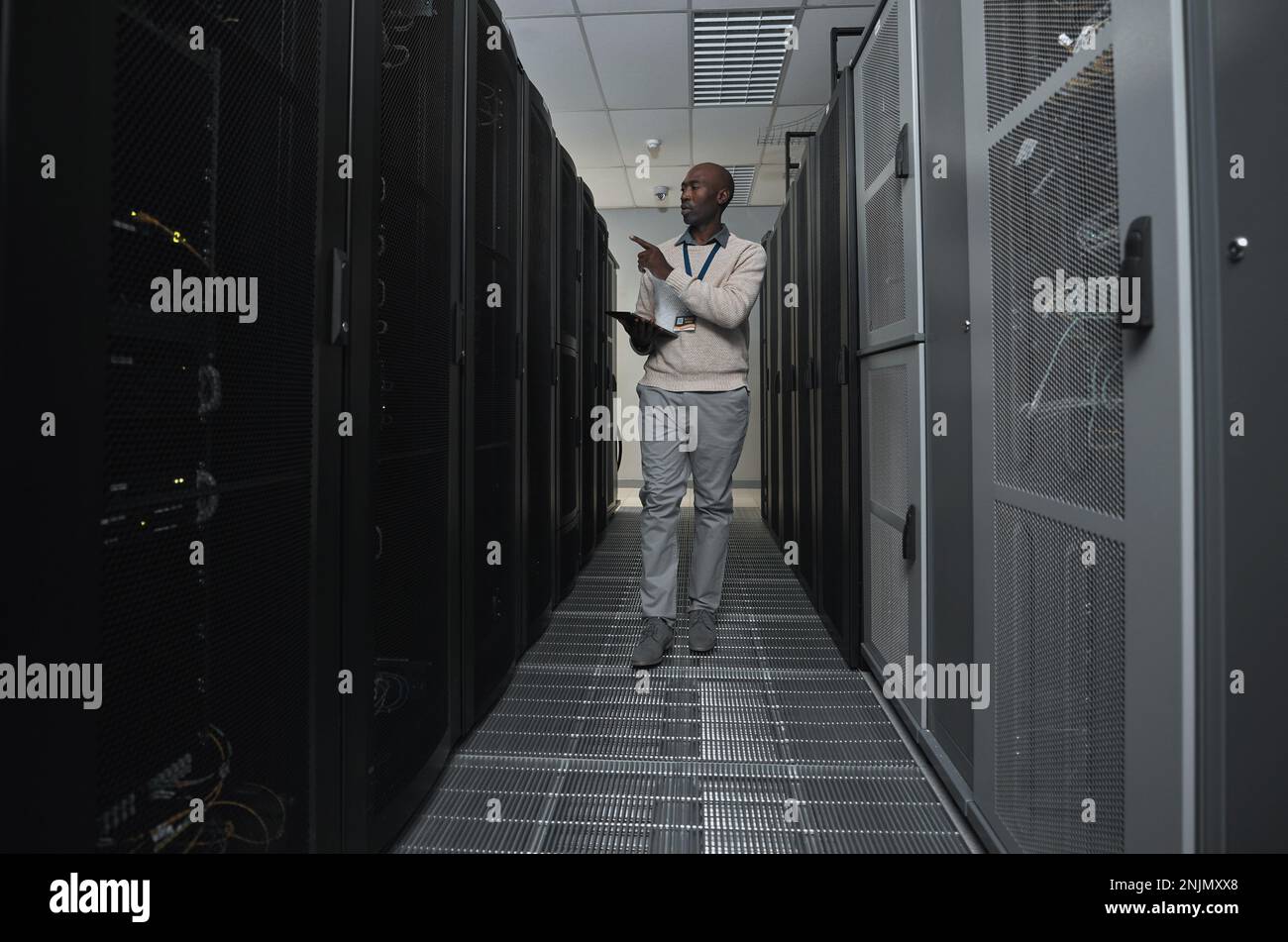 Technician, cybersecurity and man in the server room for data maintenance, it or analysis ...