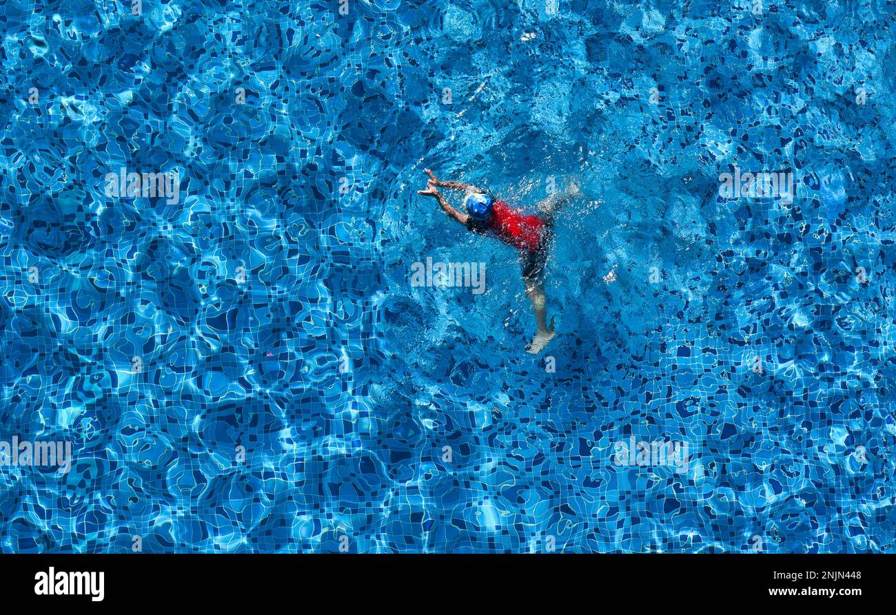 A tourist swims in a pool in a water park in Nanning in south China's ...