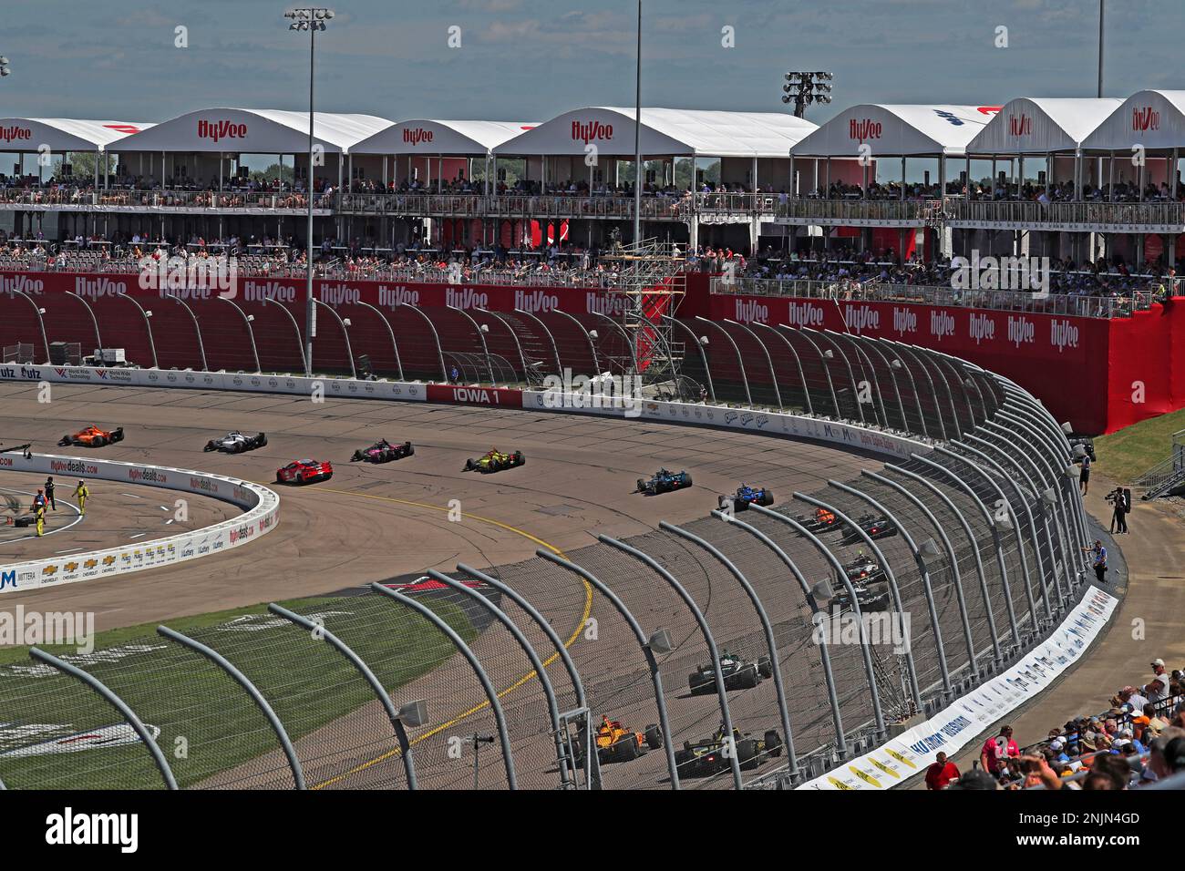 NEWTON, IA - JULY 24: NTT IndyCar series drivers race through turn one ...