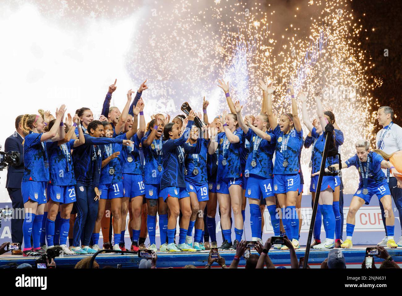 Tournament MVP Mallory Swanson (9) holds up the trophy as Team USA ...