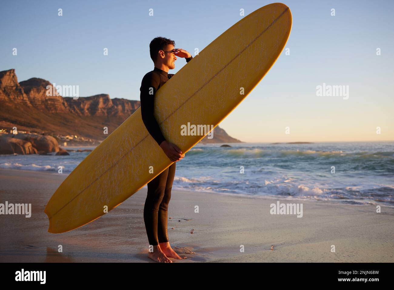 Surfer, man and beach with looking, waves and hand by eyes for safety ...