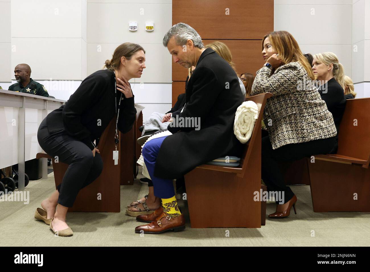 Max Schachter, center, the father of victim Alex Schachter, is consoled ...
