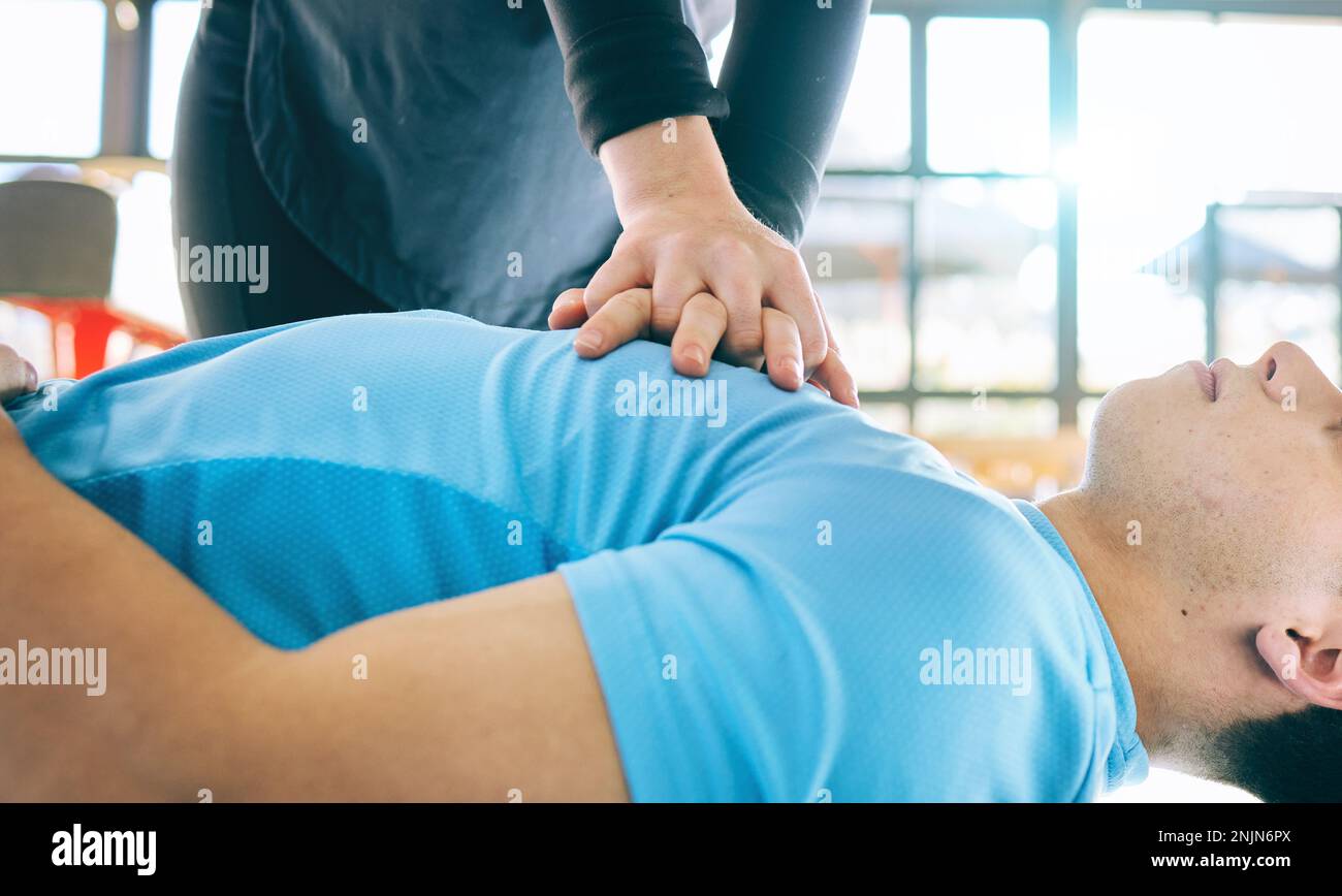 First aid, cpr and resuscitation with a woman learning how to revive a person suffering from ...