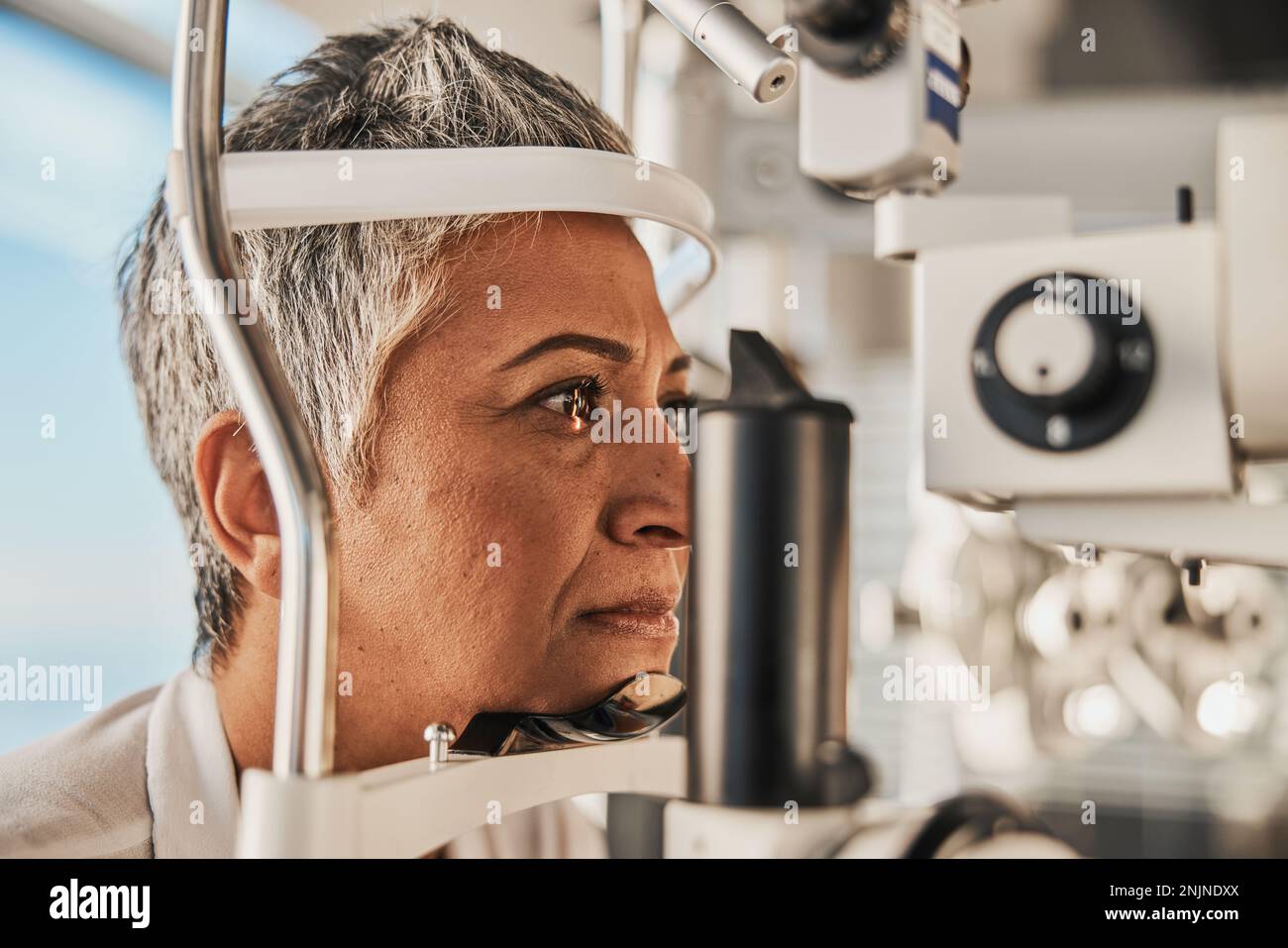 Optometry, slit lamp and eye exam by senior woman or patient with ...