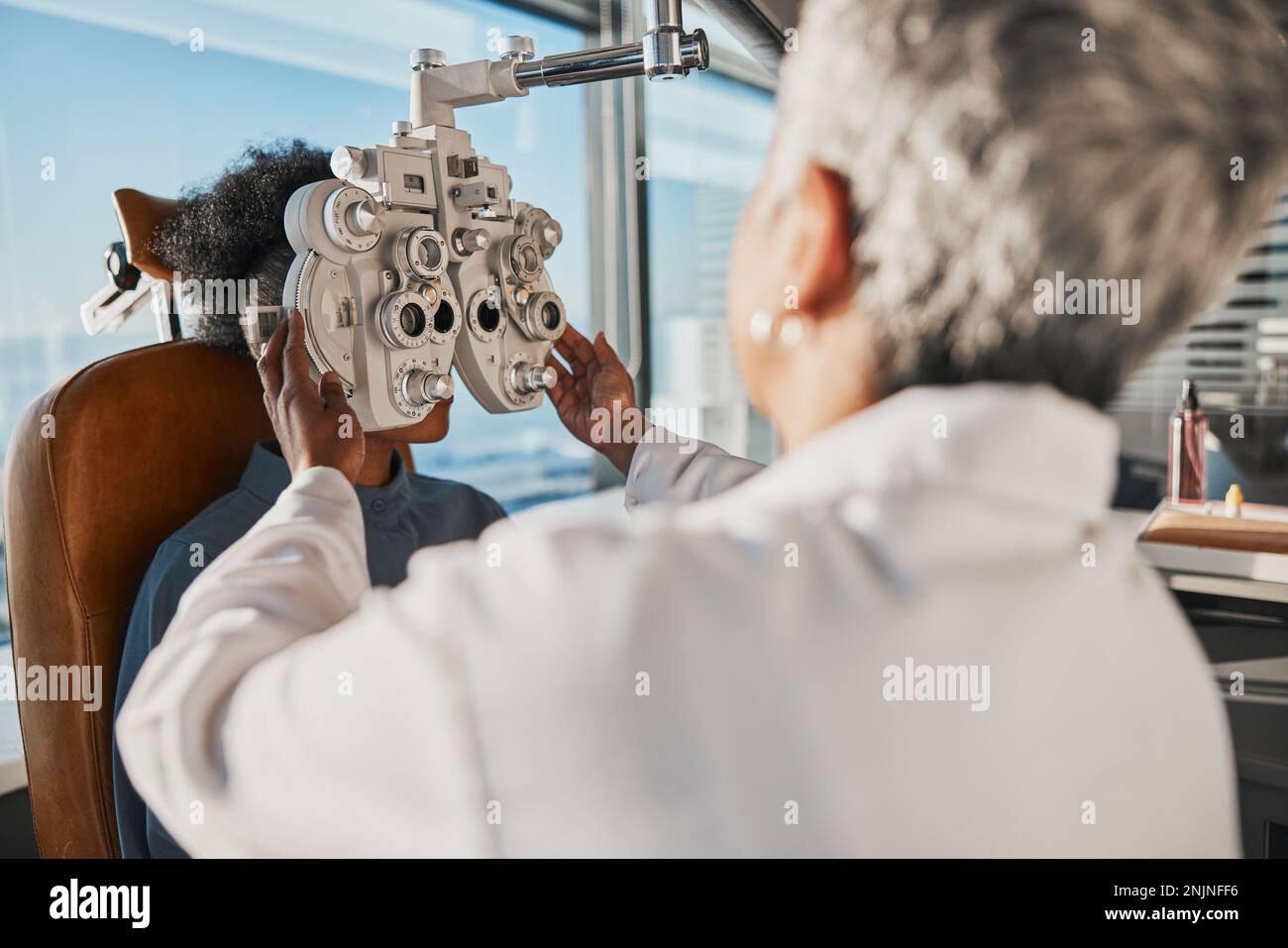 Optometry, eyecare and optician doing a eye test for a patient for ...