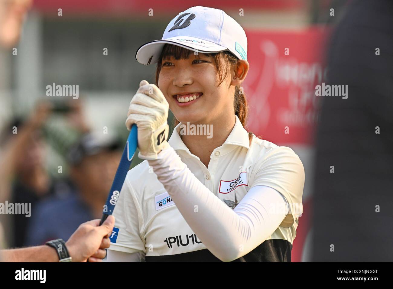 Saki Baba of Japan smiles before her tee-off of the 10th hole during ...