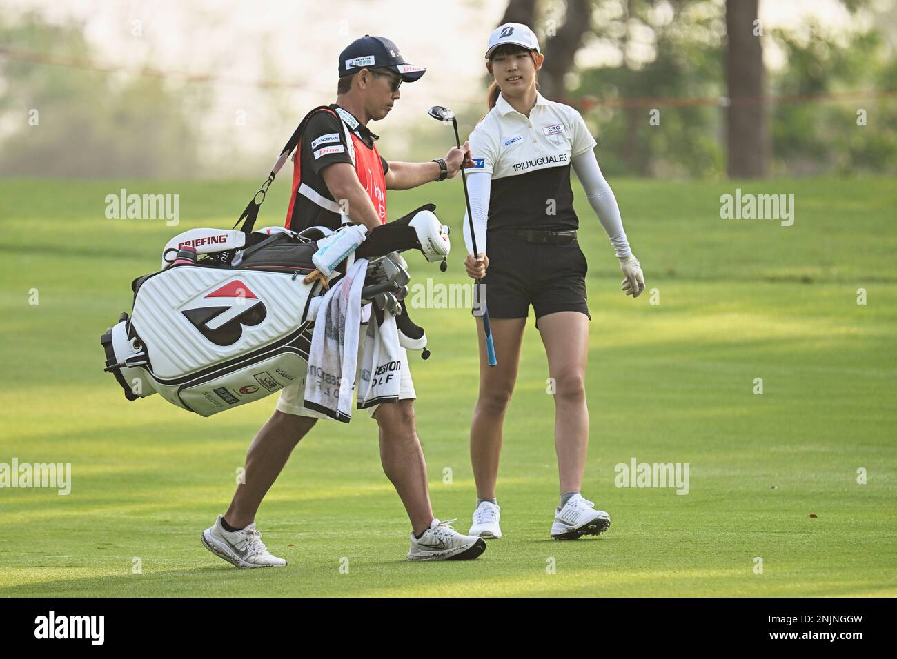 Saki Baba of Japan gives her club to her caddie on the 10th hole during ...