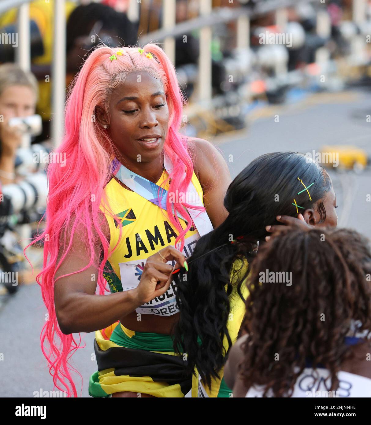 Shelly-Ann Fraser-Pryce of Jamaica unties Shericka Jackson's hair after ...