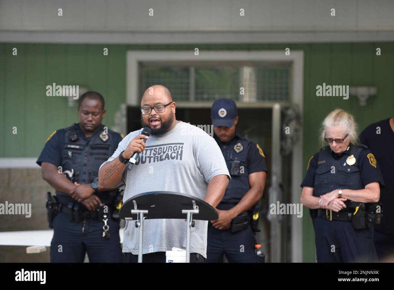 Rev. Cornell Jones honors police officers, from left, Brian Shelton ...