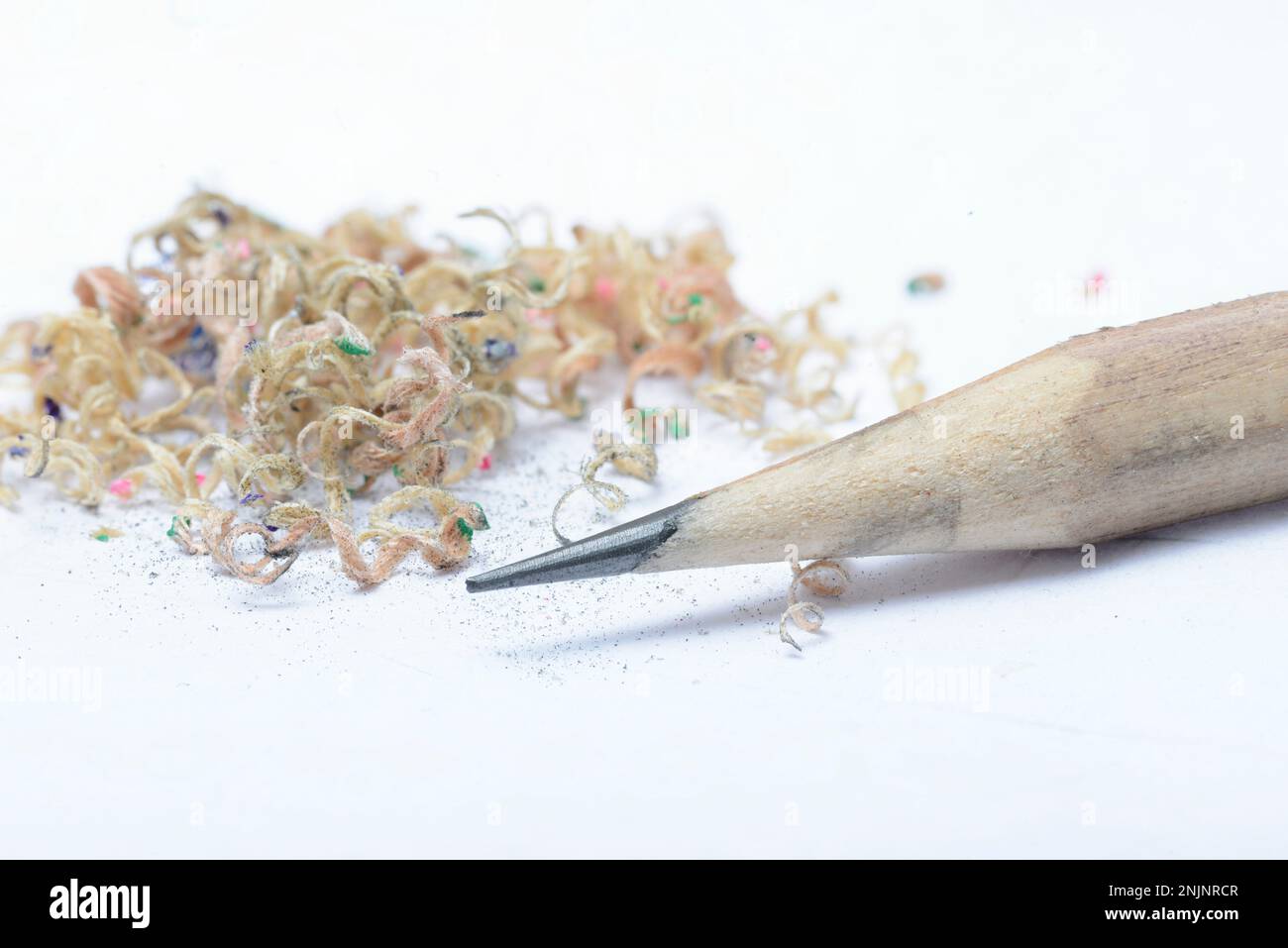 sharp pencil fragment with wooden peeling on white background Stock ...