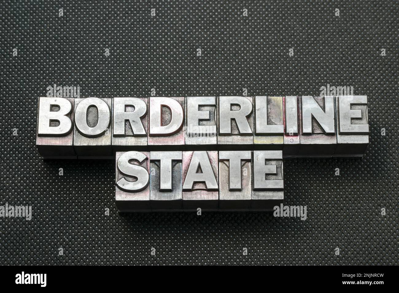borderline state phrase made from metallic letterpress blocks on black ...