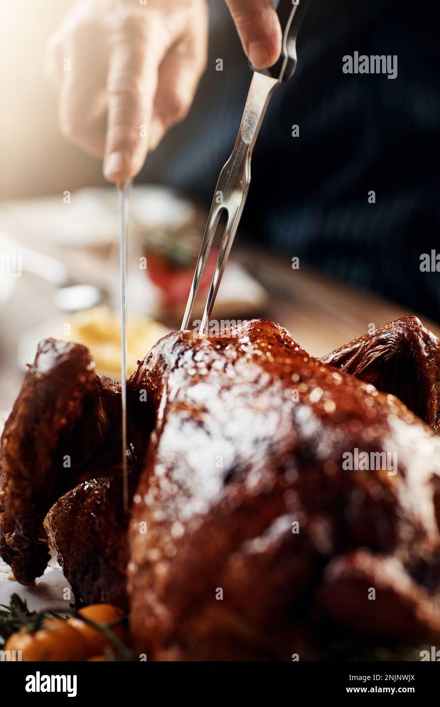 Time to carve the turkey. Closeup shot of an unrecognizable man cutting ...