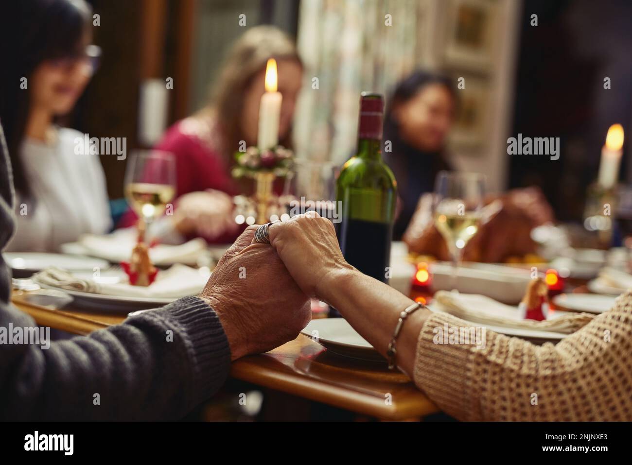 First we pray then we feast. Closeup shot of people holding hands in ...