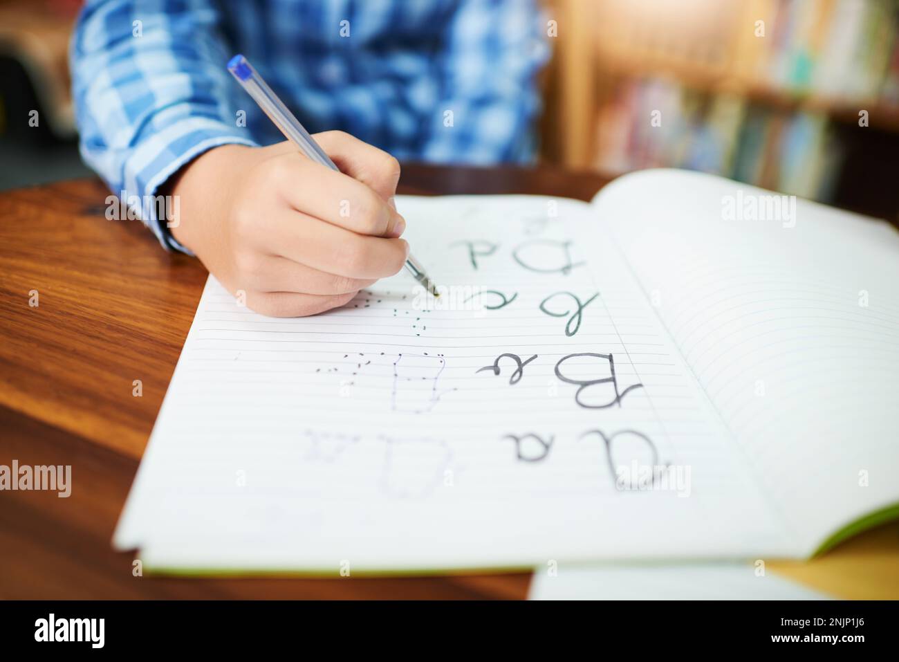 Getting some math in. Closeup of an unrecognizable young boy working ...