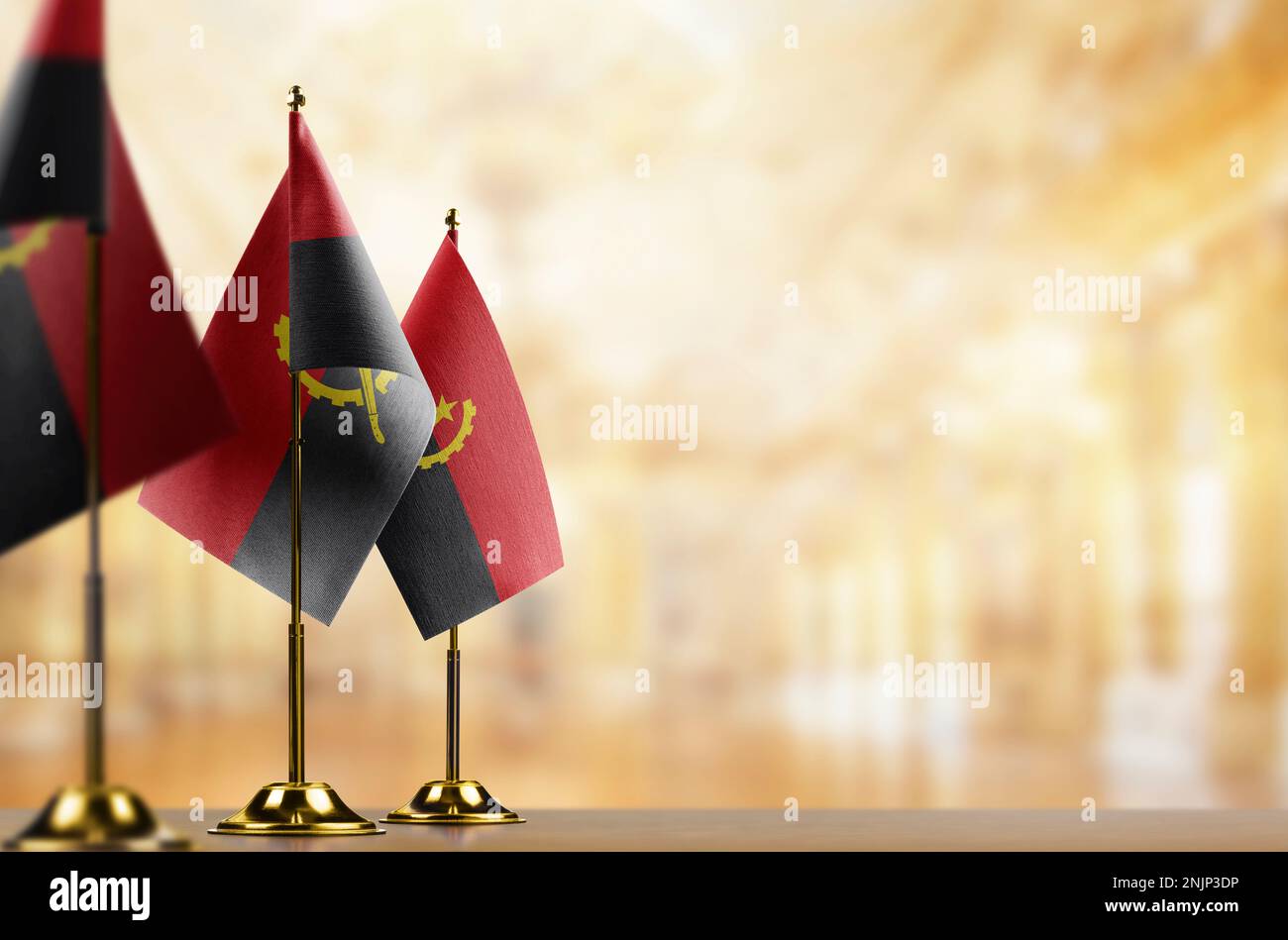 A small Angola flag on an abstract blurry background Stock Photo - Alamy