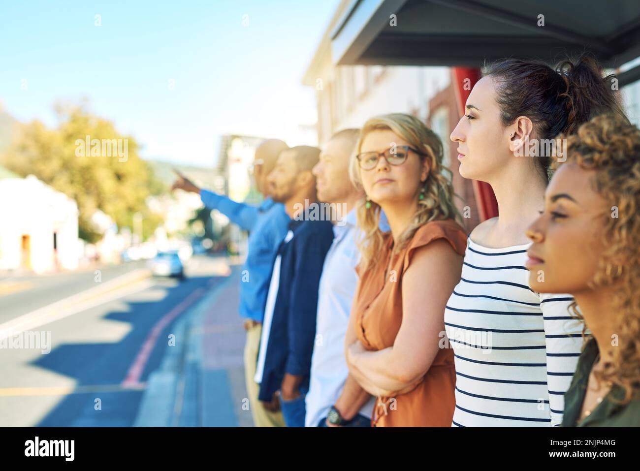 Waiting together. a group friends standing and looking into the ...