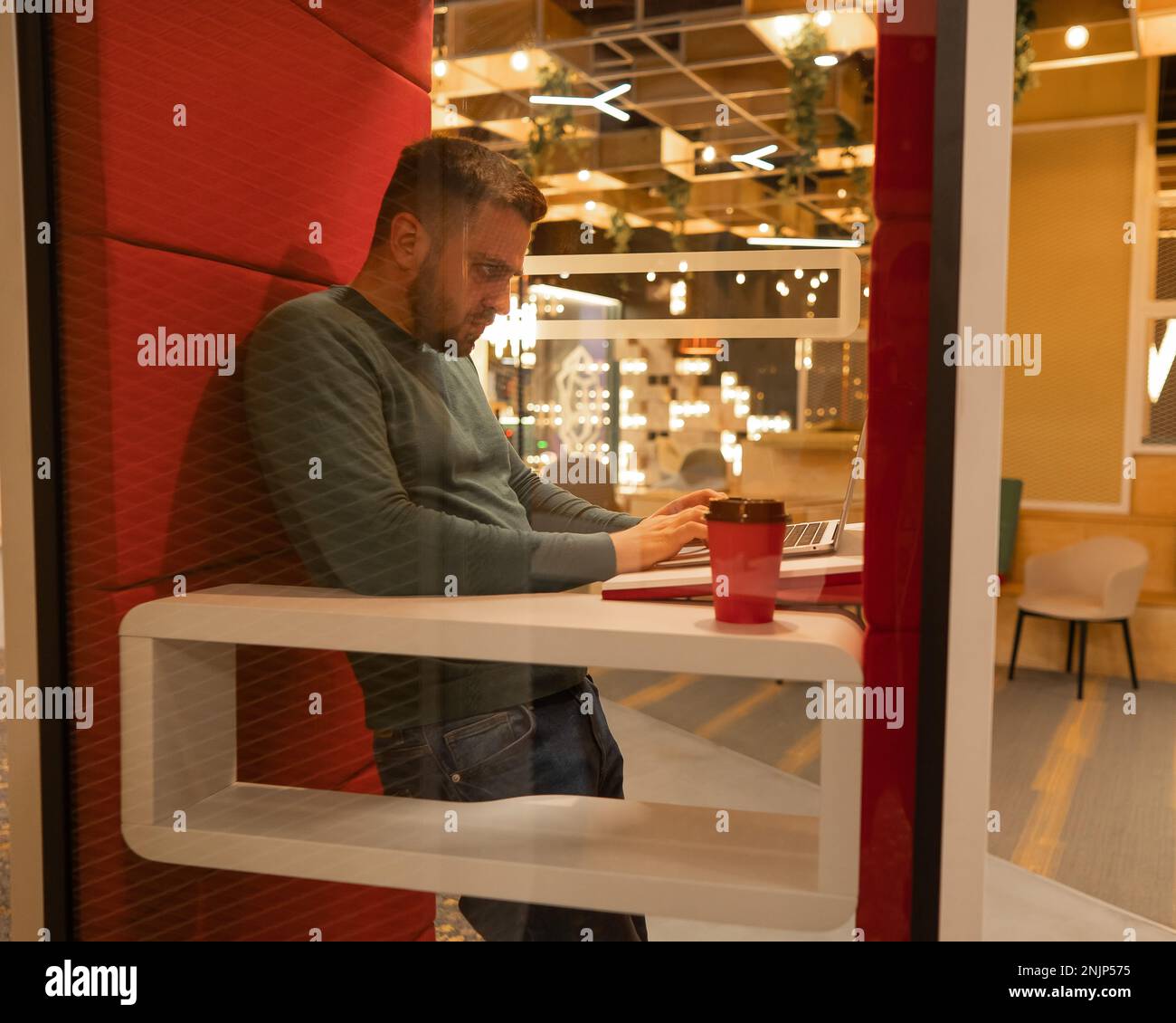 A bearded man in a booth for online negotiations. Privacy booth Stock ...