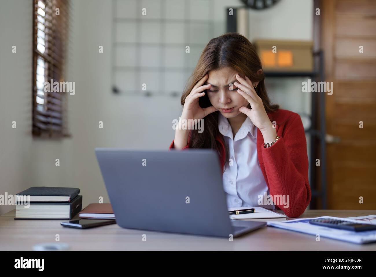 Tired young asian business woman with headache at office, feeling sick ...