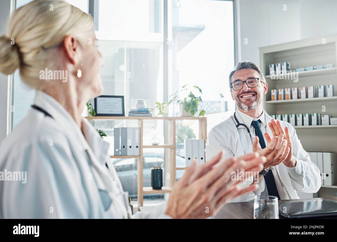 Doctors, applause and support with medical success for team building or ...